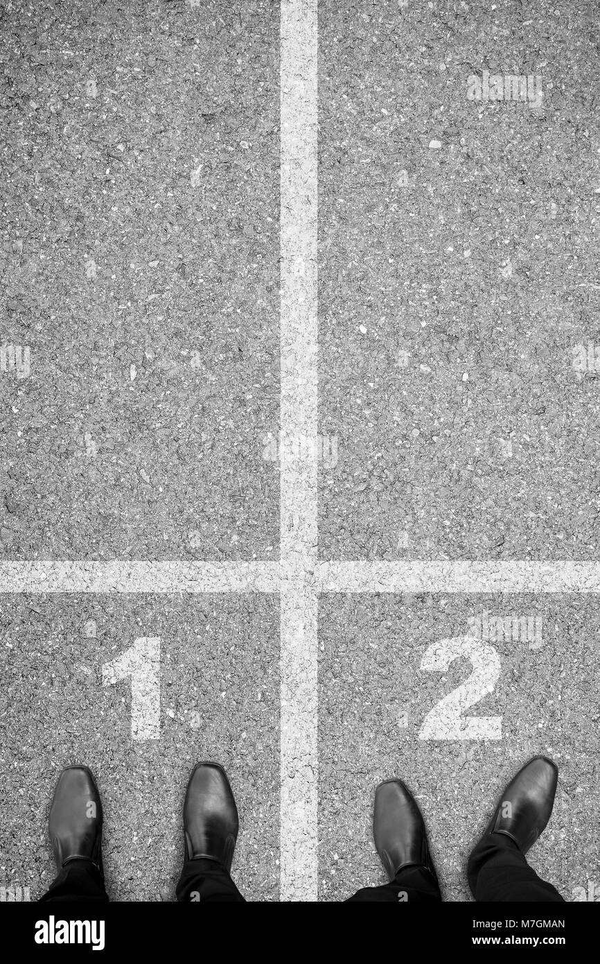 Two rival competent businessmen standing at start point ready to start ...