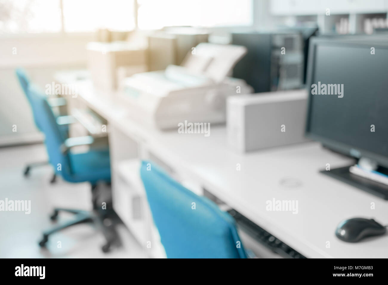 Abstract blur office interior - chair, desk, computer, monitor, printer ...
