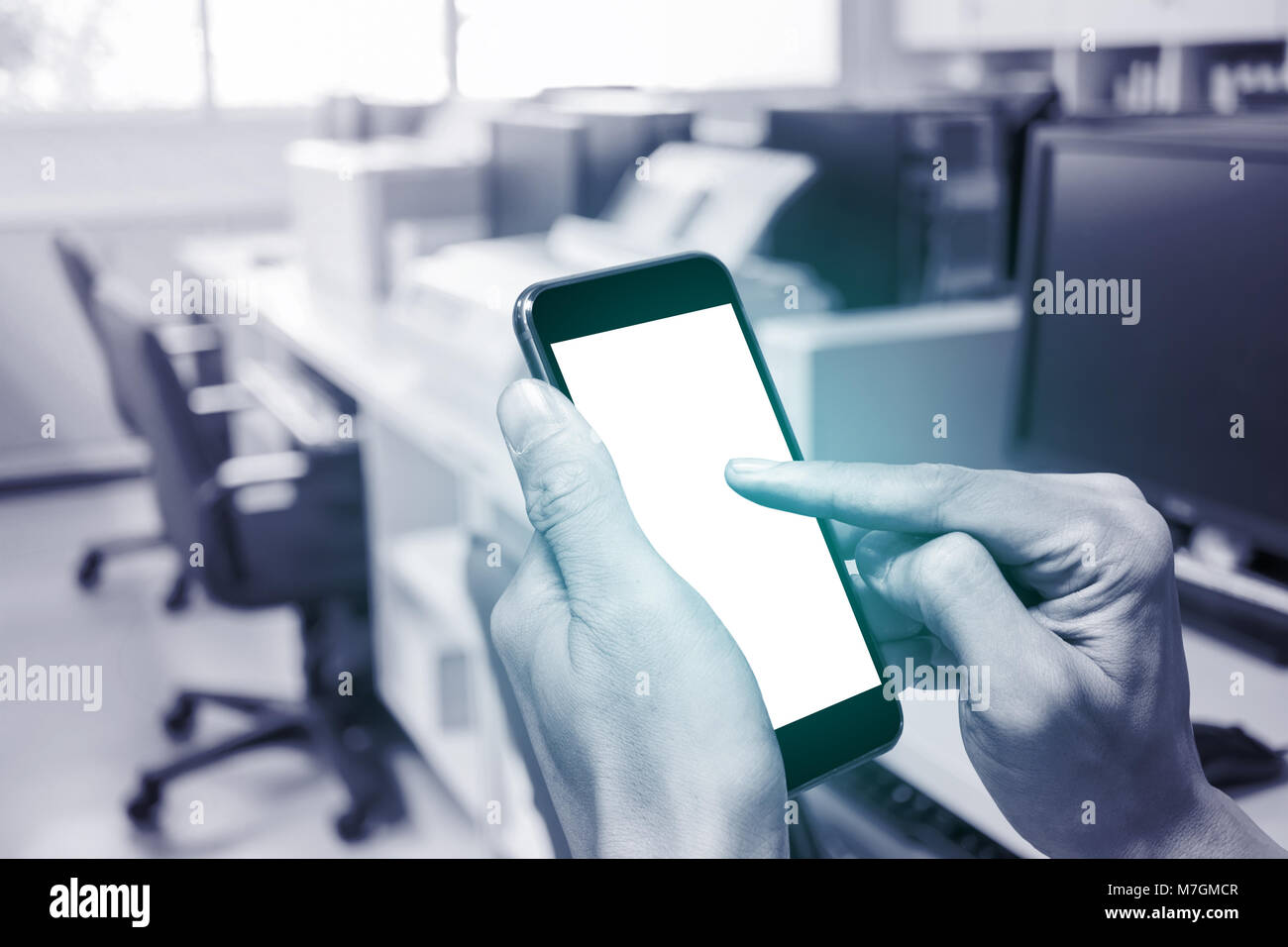One using smart phone in working office. Abstract blur office ...