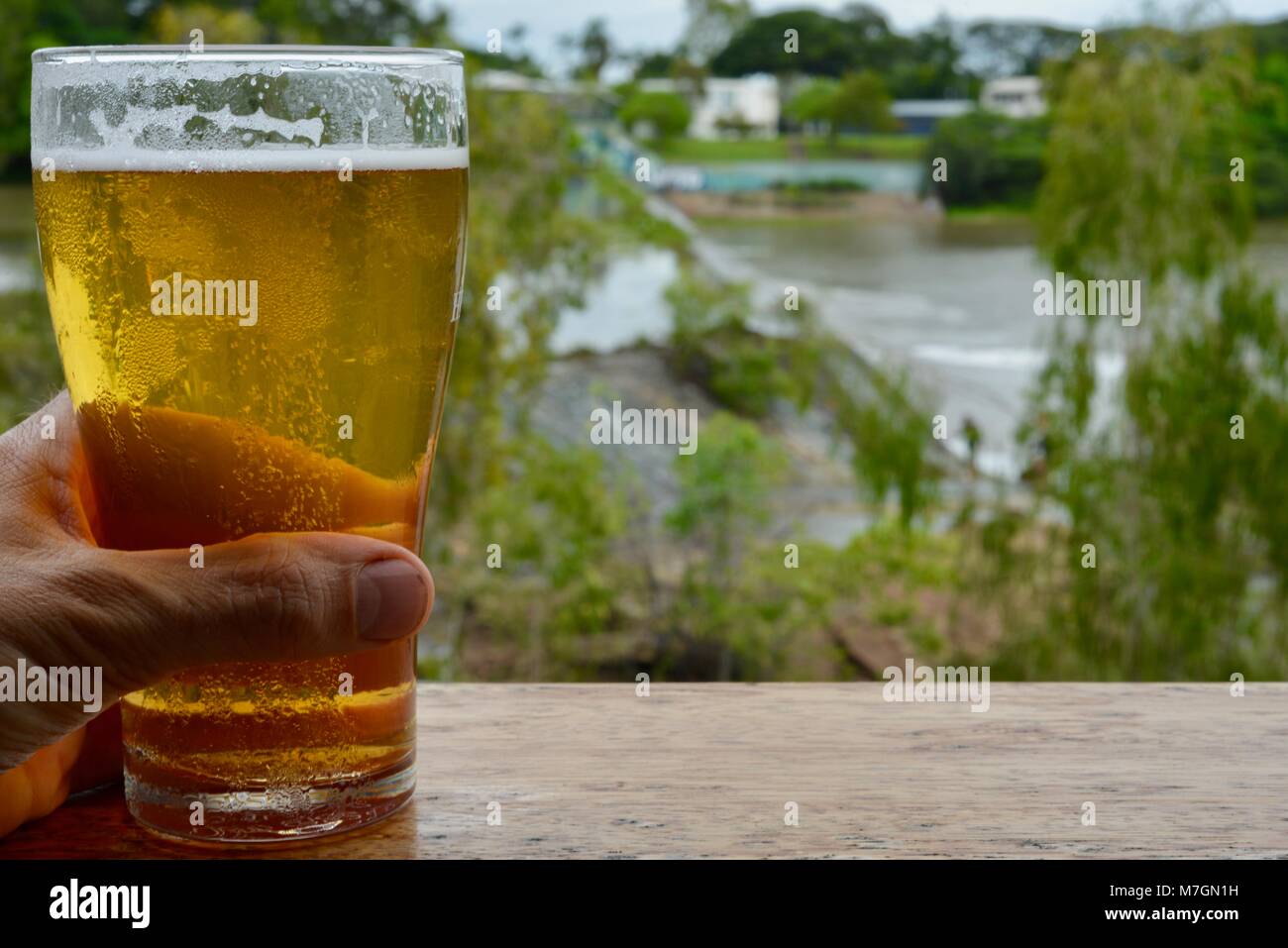 Drinking a beer with views of water overflowing the weir after recent ...