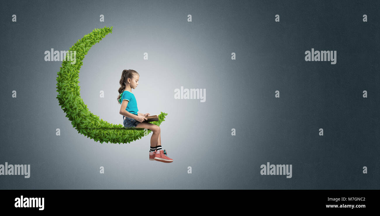Cute kid girl sitting on green moon and looking away Stock Photo - Alamy