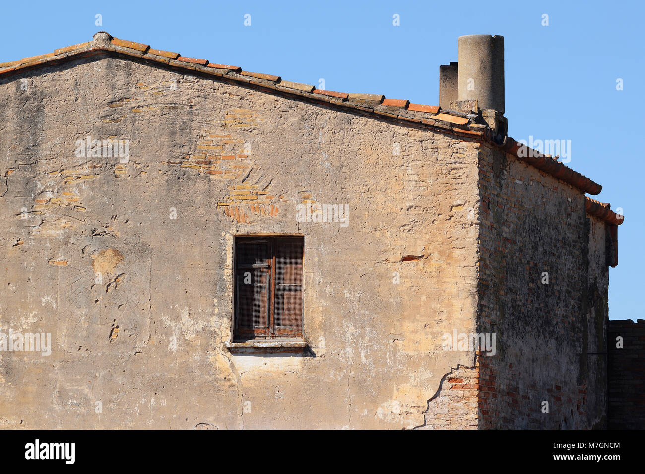 Damaged facade of a rural house used as a farmhouse tourism. Empty copy ...