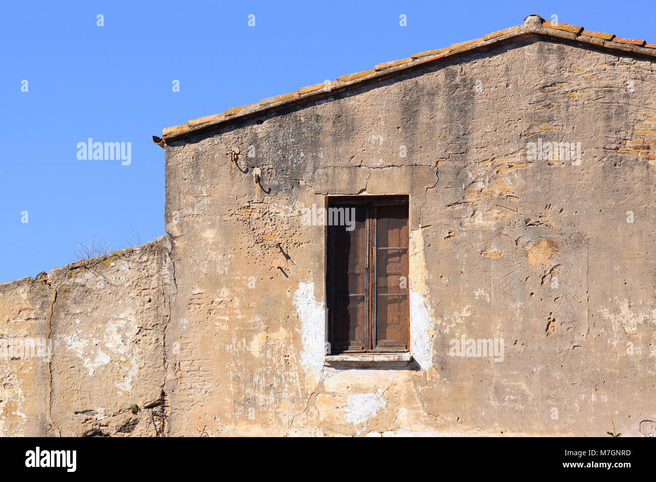 Damaged facade of a rural house used as a farmhouse tourism. Empty copy ...