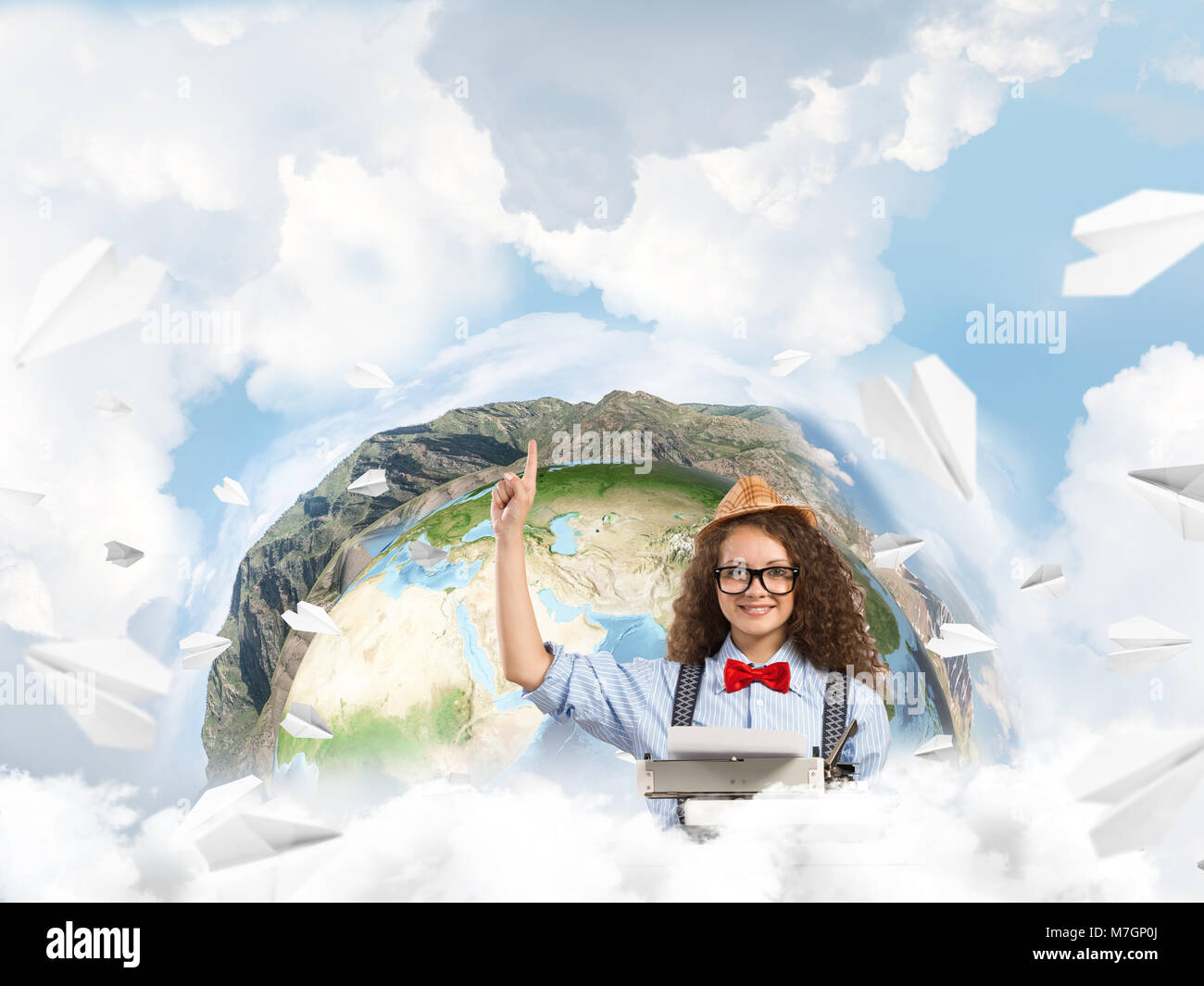 Beautiful woman writer in hat and eyeglasses pointing up while using ...