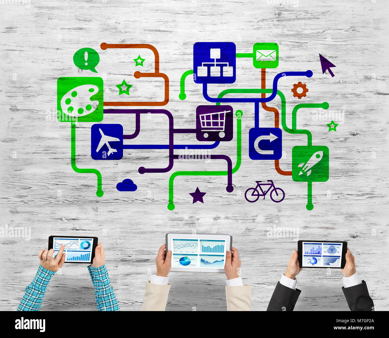 Group of three people with devices in hands working together as symbol ...