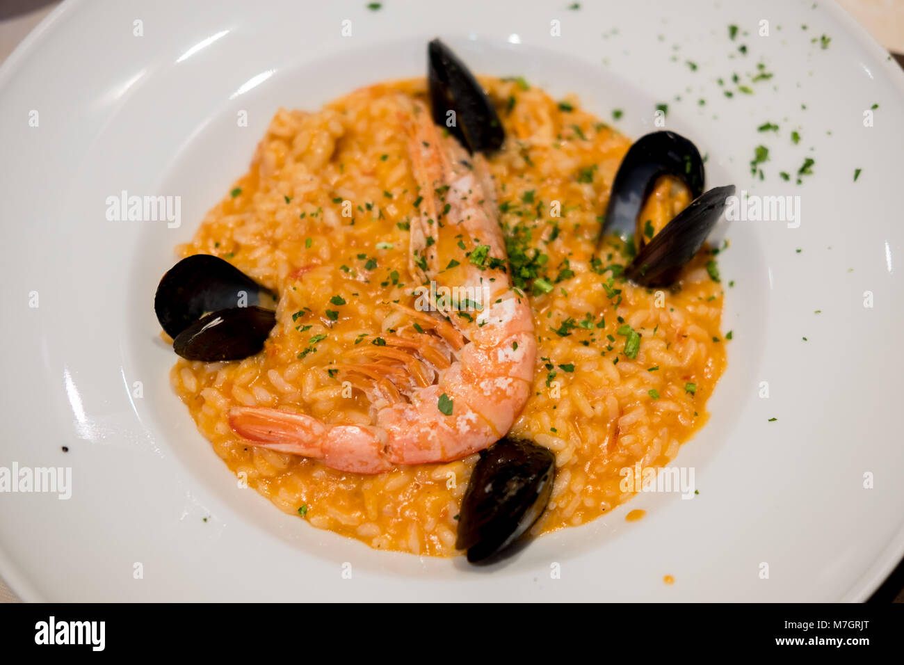 Close up of Seafood Risotto served on plate Stock Photo - Alamy