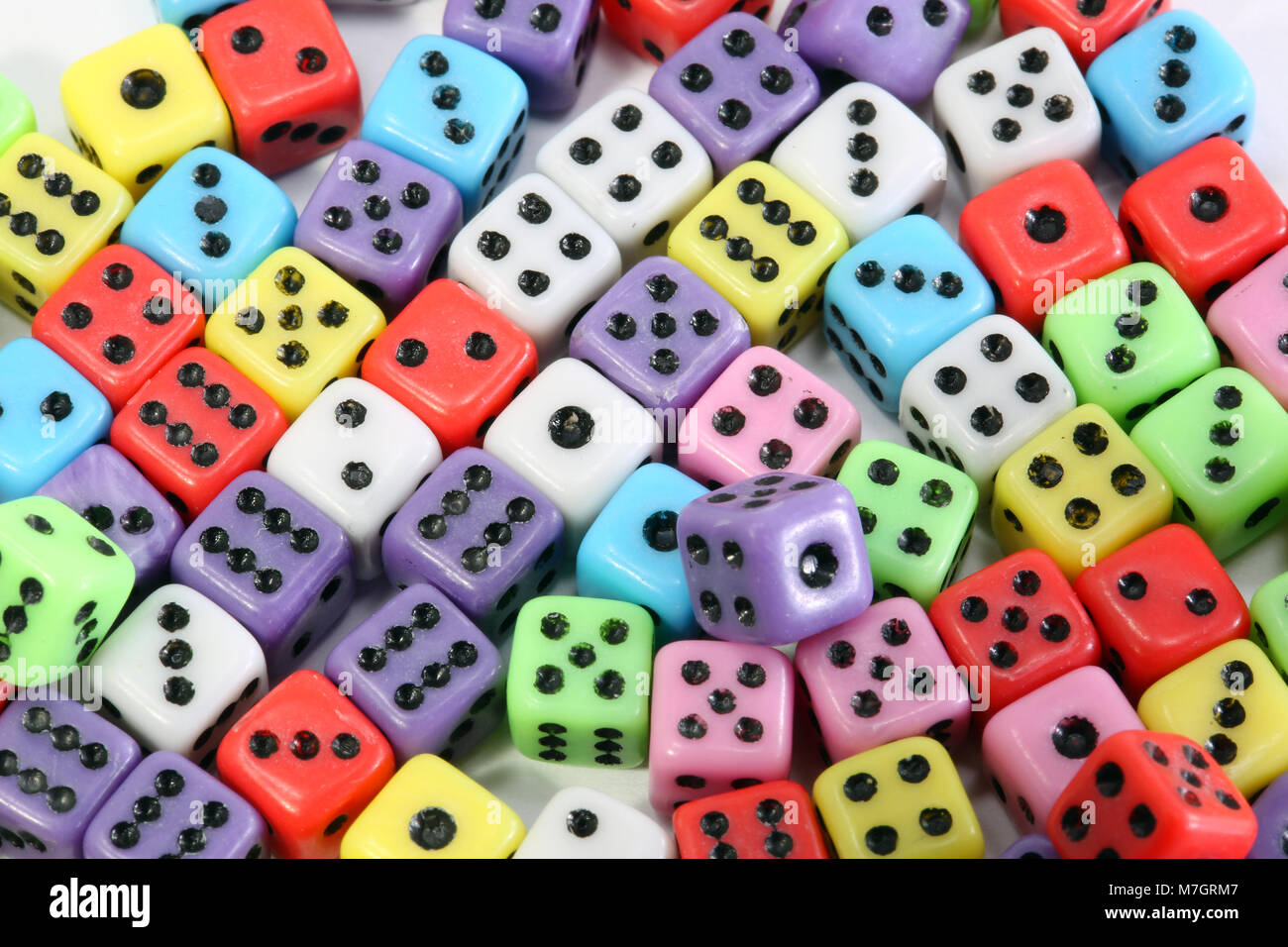 background of many colored gaming dice with black dots Stock Photo - Alamy