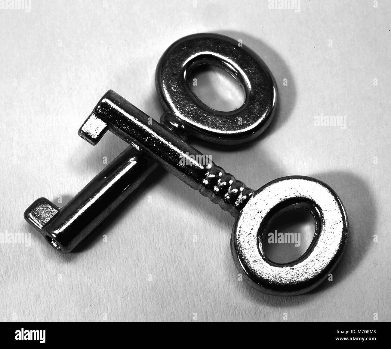 two metallic keys of gold and silver with dark effect in black and ...