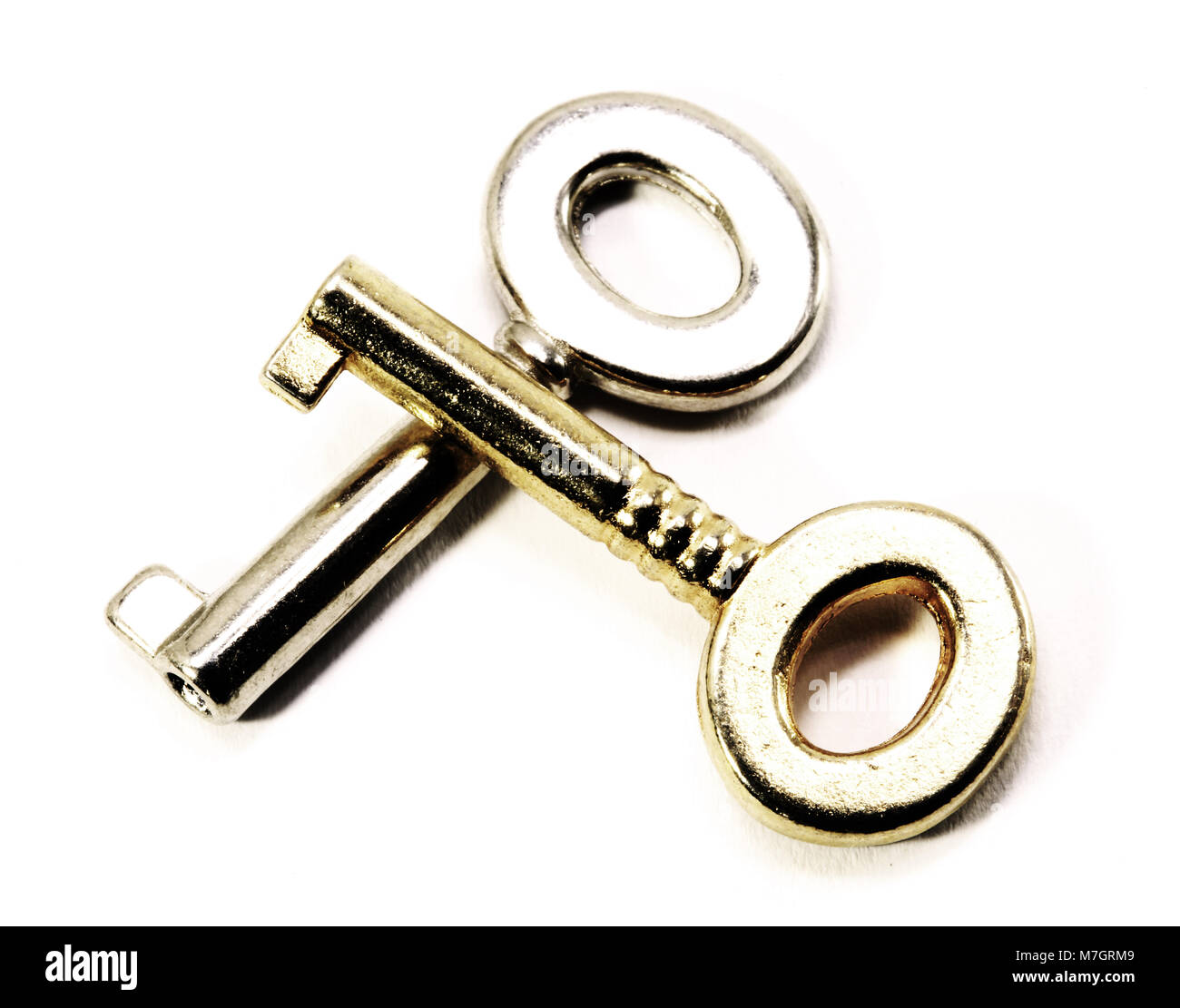 two metallic keys of gold and silver with a very light effect Stock ...