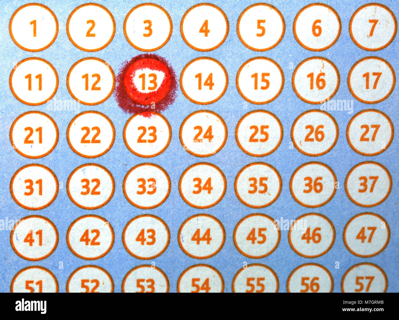 The number 13 circled in red in a lottery bingo card Stock Photo - Alamy