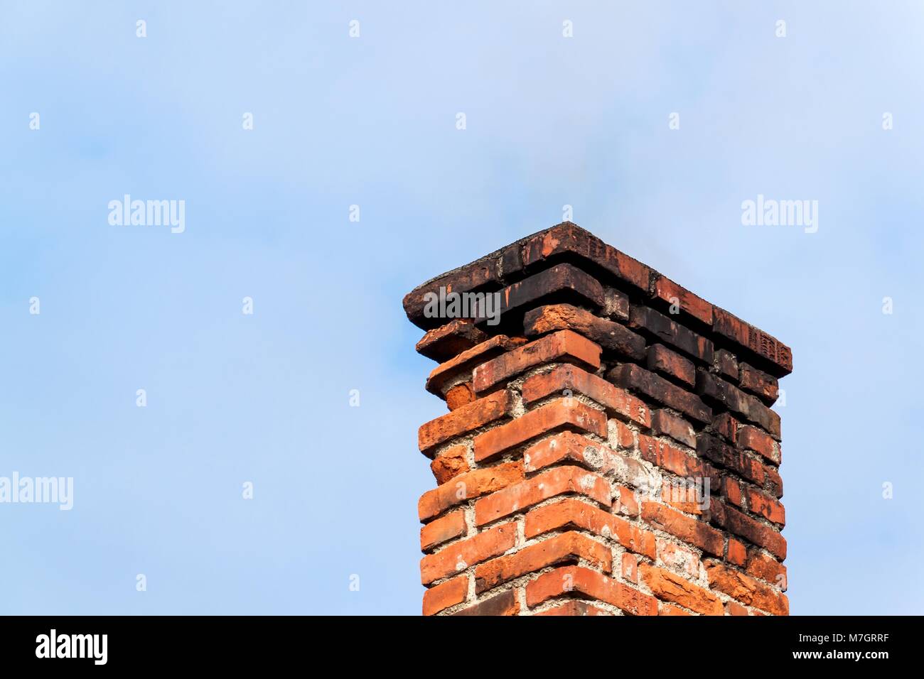 Old brick chimney. Chimney with sky in the background. Eco-friendly ...