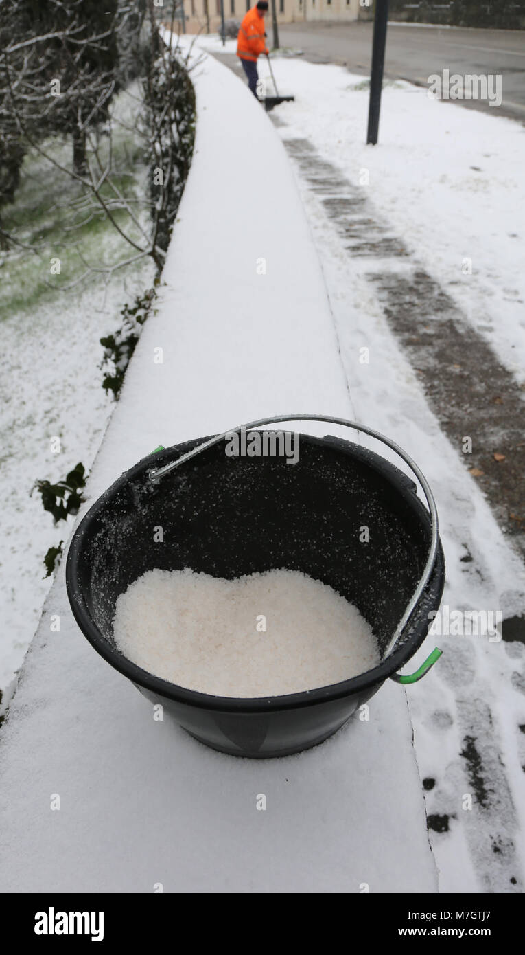 bucket with salt to avoid the falls on the ice of the sidewalk and the ...