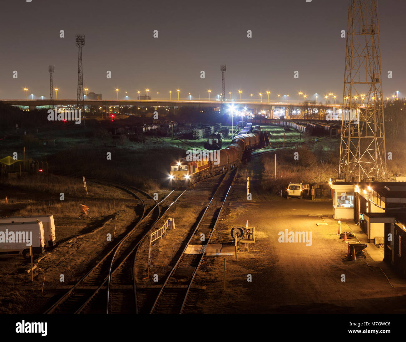 A DB Cargo class 66 locomotive in Tees yard, Thornaby, Teeside at night ...