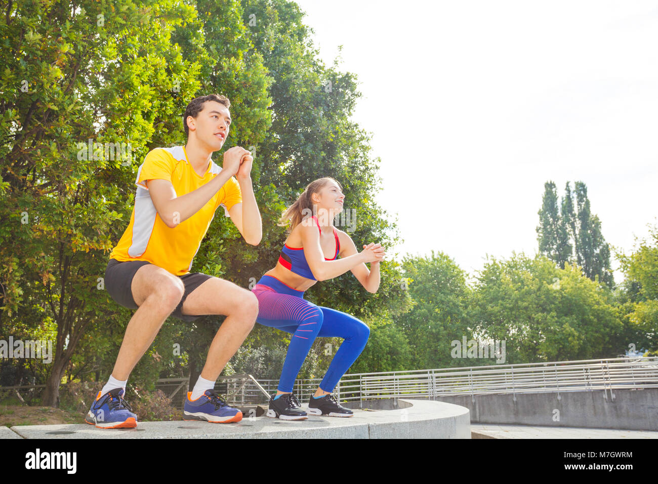 Active young people doing jump exercise during crossfit workout at city ...