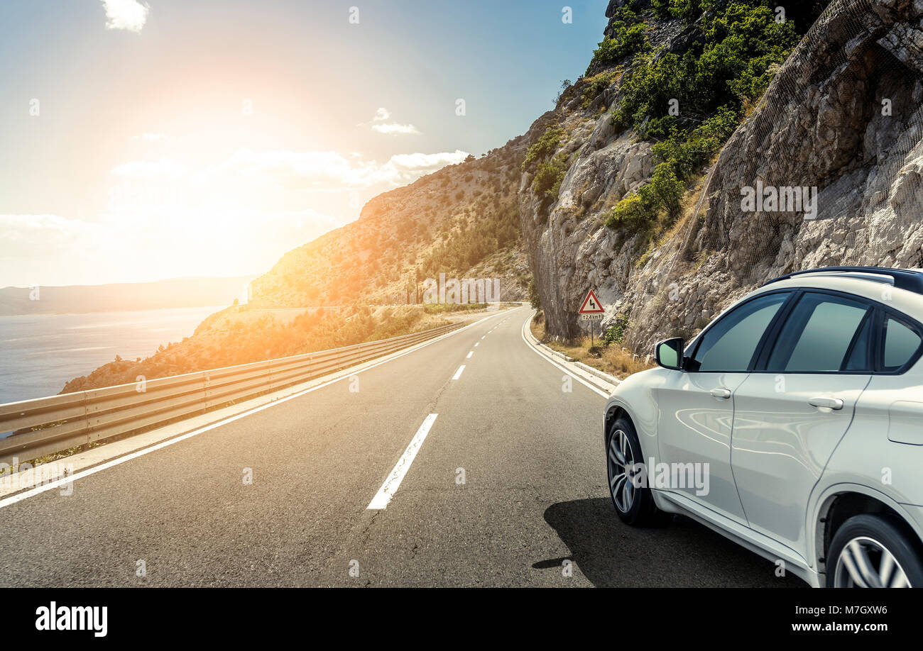 White car rushing along a high-speed highway. Toned photo Stock Photo ...