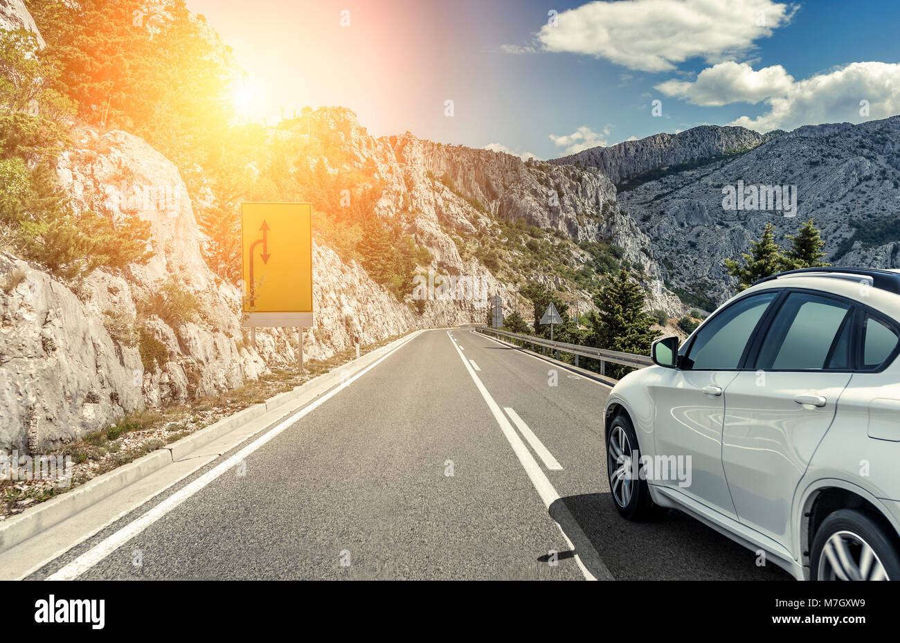 White car rushing along a high-speed highway. Toned photo Stock Photo ...