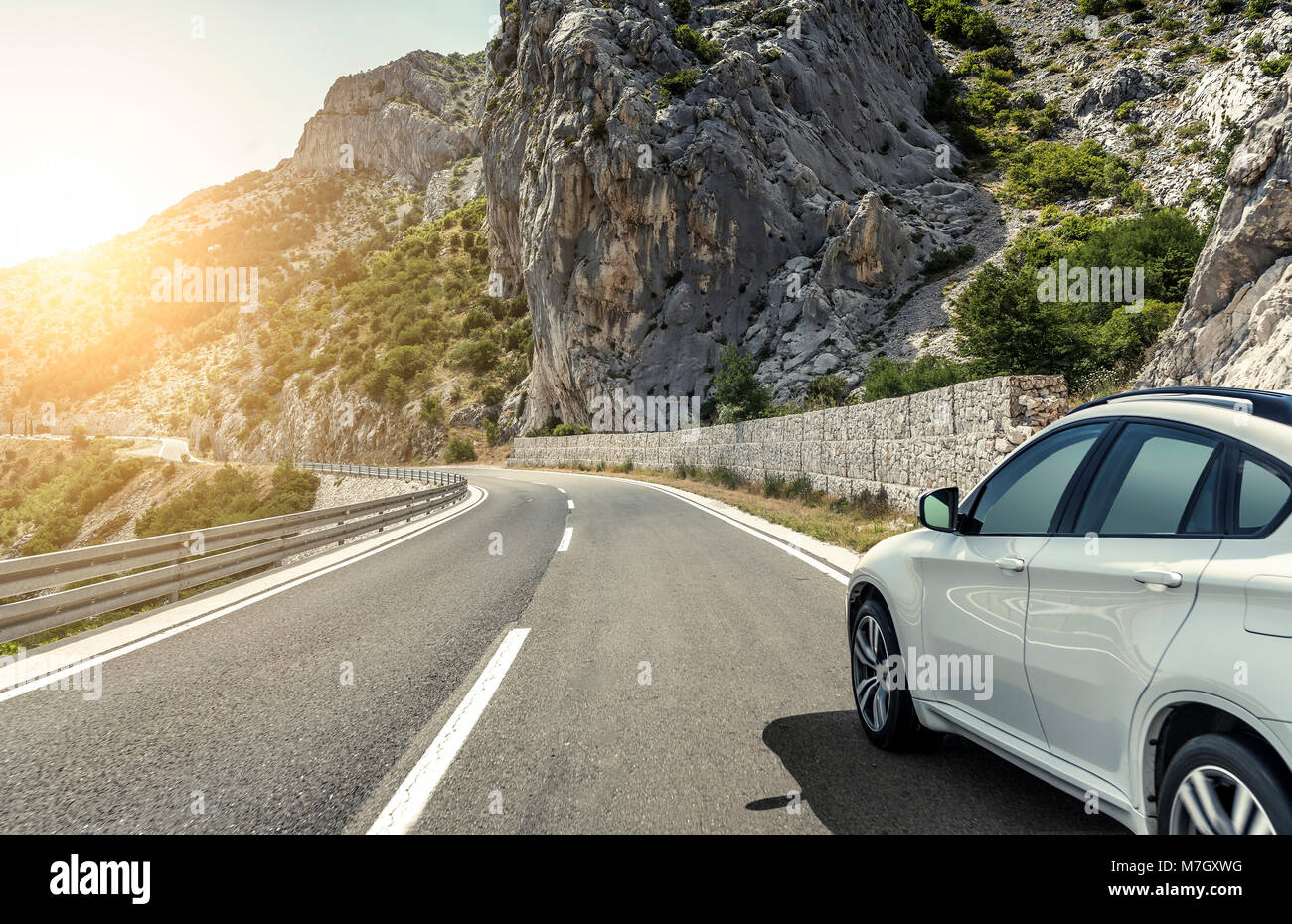 White car rushing along a high-speed highway. Toned photo Stock Photo ...