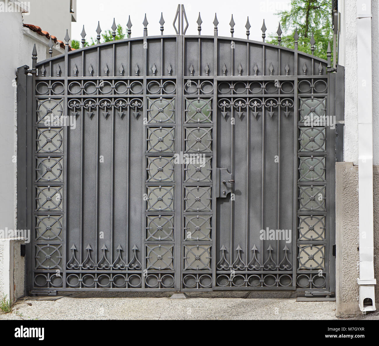 Closed gray iron gate house exterior Stock Photo - Alamy