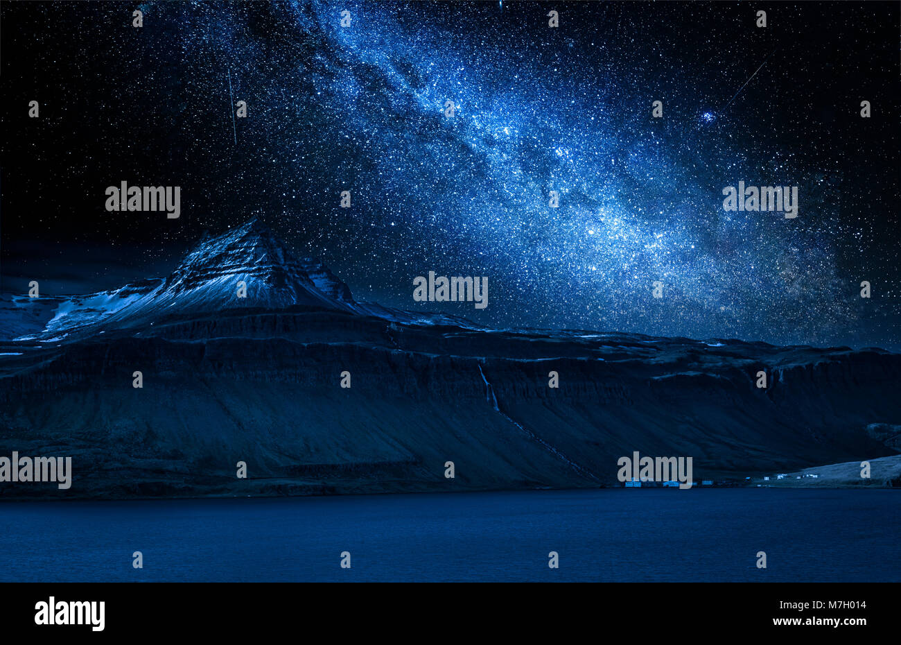 Milky way and volcanic mountain over fjord at night, Iceland Stock ...