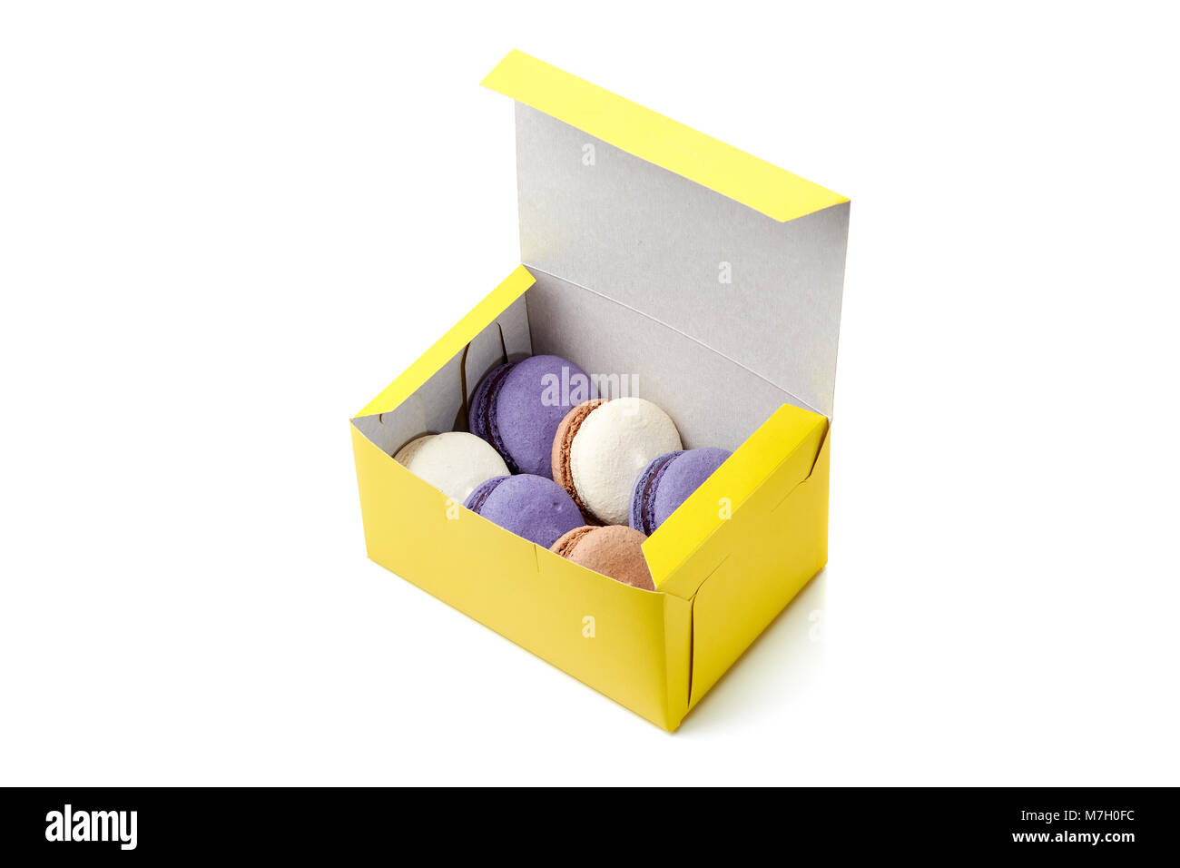 Yellow packing box with colorful macaroons on white Stock Photo - Alamy