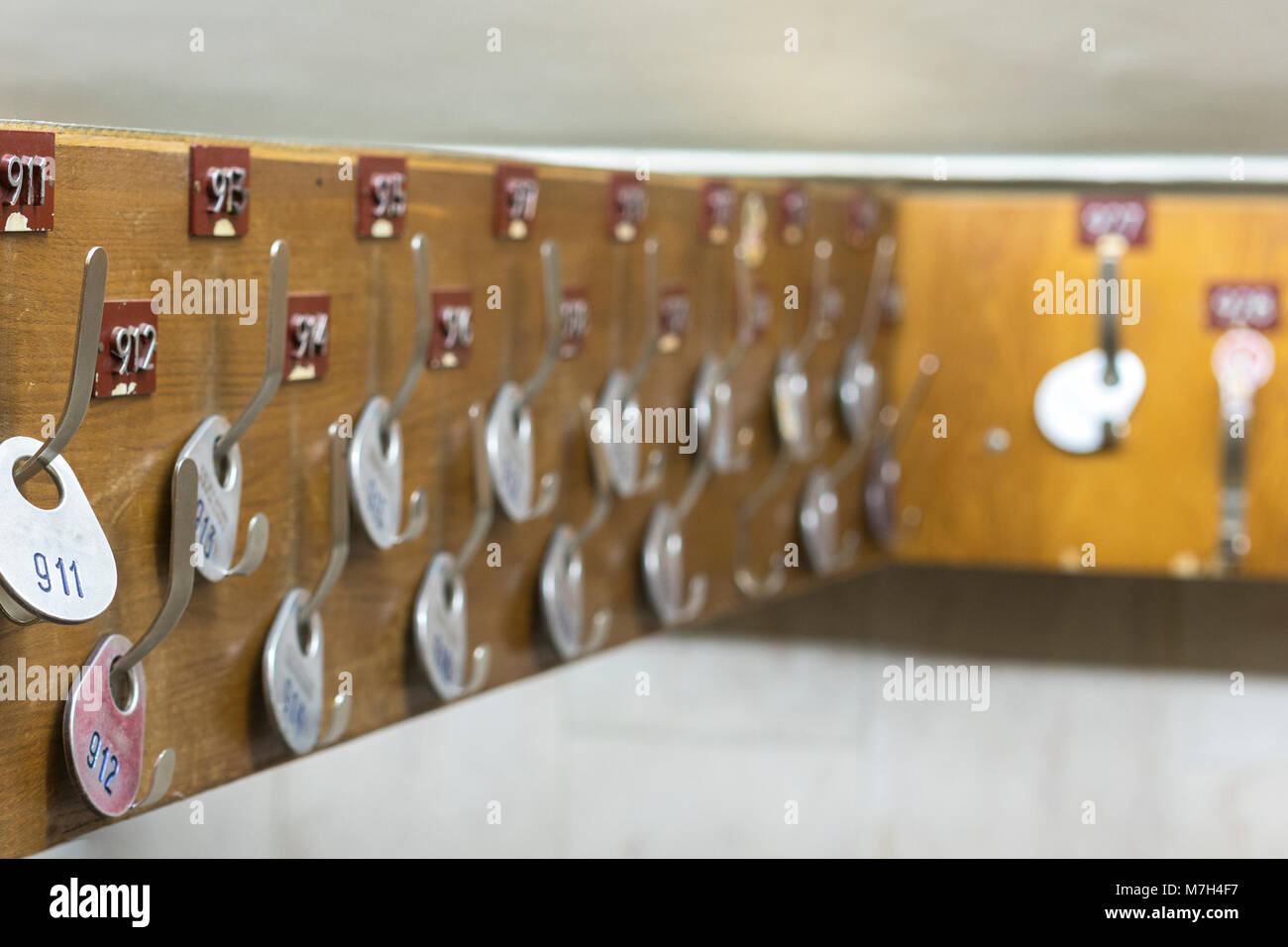 Hooks for clothes with numbers in the locker room Stock Photo - Alamy