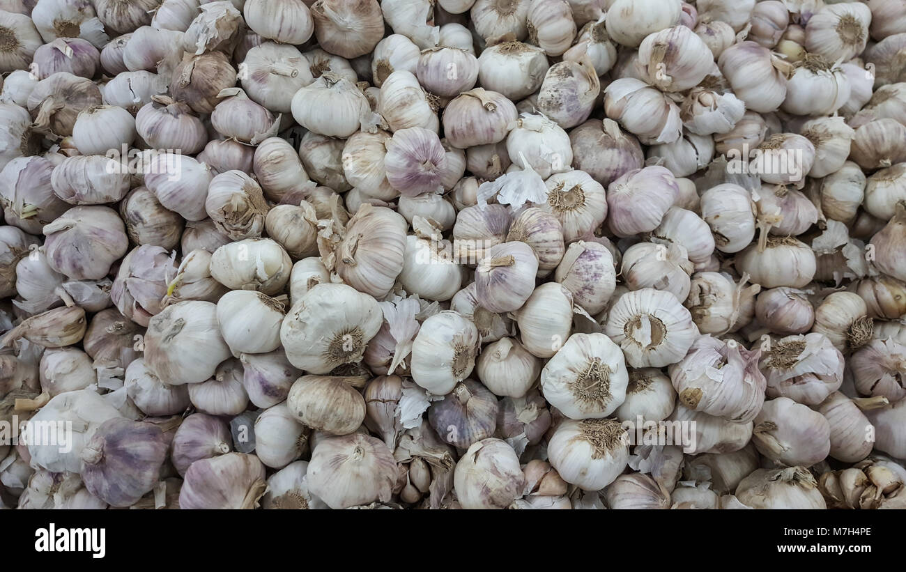 Stack of white garlic, display at wet market Stock Photo - Alamy