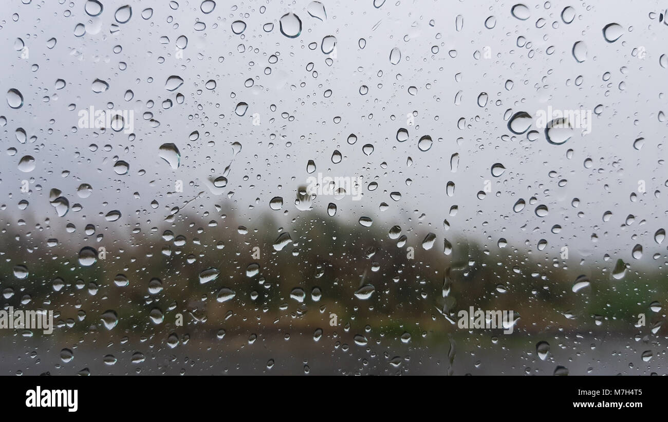 Rainy day, rain drops display on car window Stock Photo - Alamy