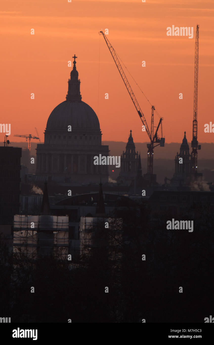 Commuters stop to take photos of the stunning sunrise across London at ...