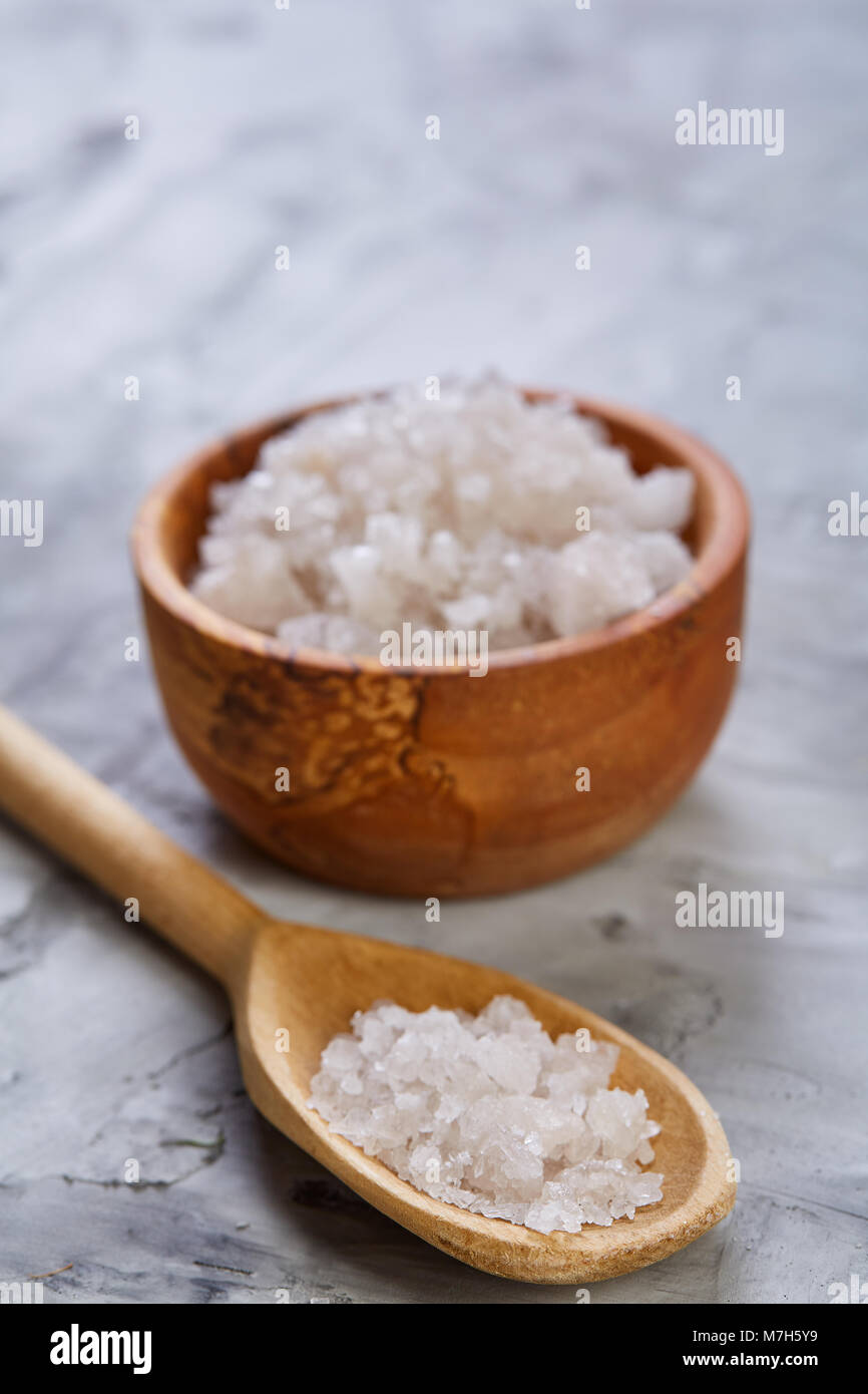 Large white sea salt crystals in a natural wooden bowl and wooden scoop ...
