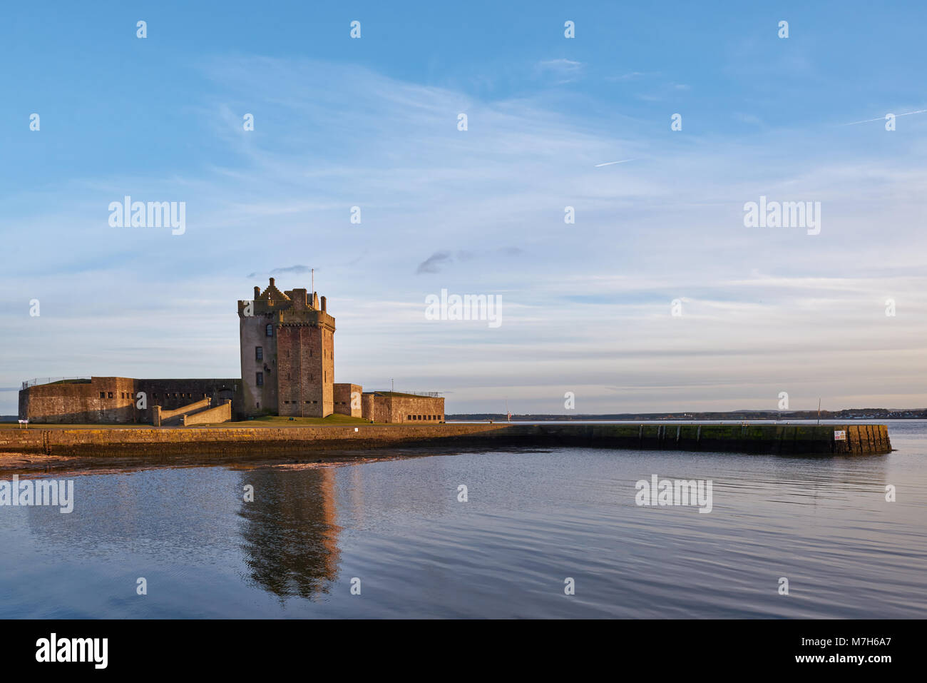 The Setting sun from the Tay Estuary reflects off the Fortified walls ...