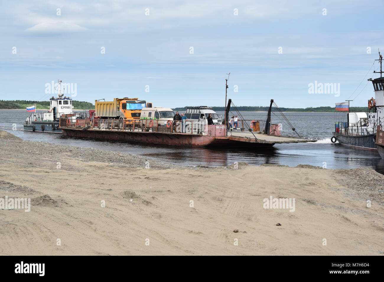 The ferryboat ready for landing on the river Aldan bank near the town ...