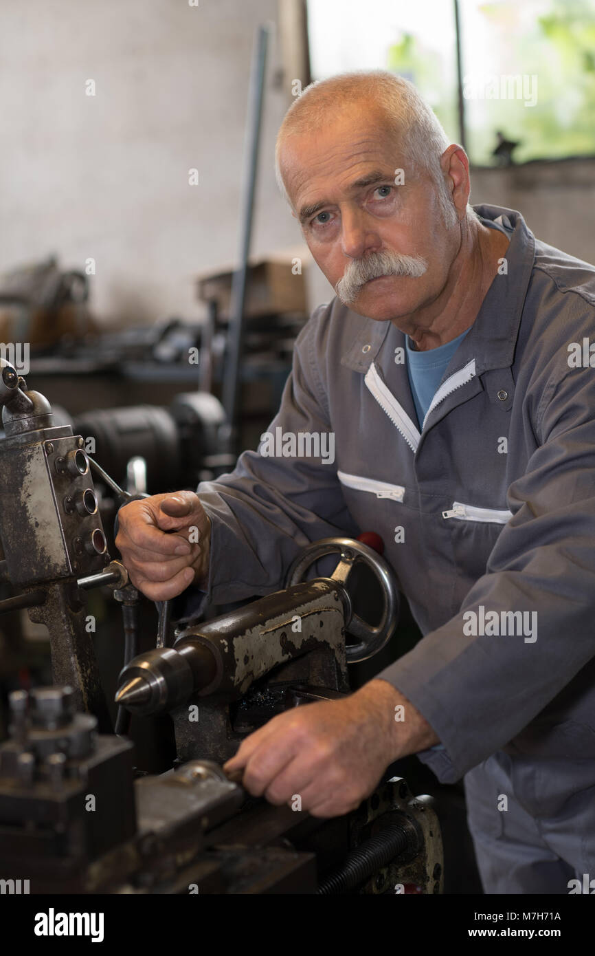 old mechanic working on factory machine Stock Photo - Alamy