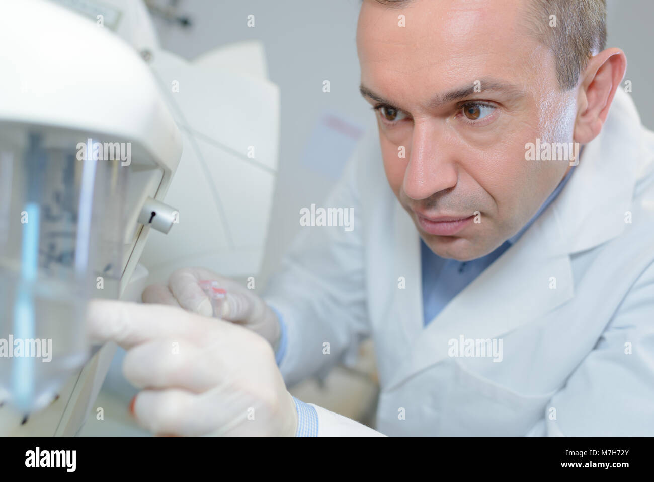 Male medical worker adjusting machine Stock Photo - Alamy