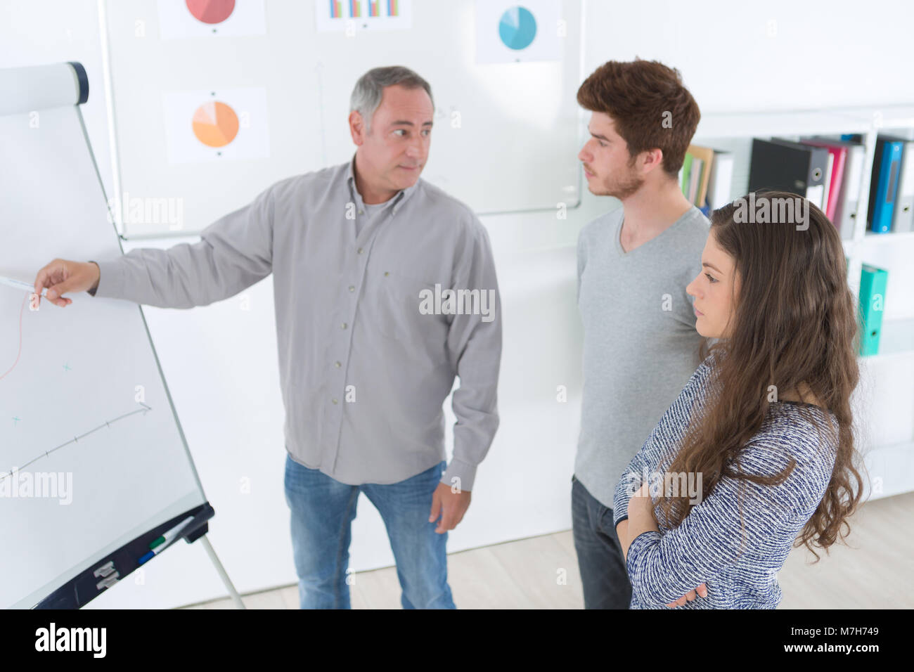 businessman teaching younger students in a modern class Stock Photo - Alamy