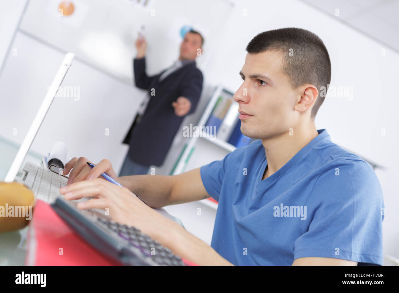 student working out problems on his calculator Stock Photo - Alamy