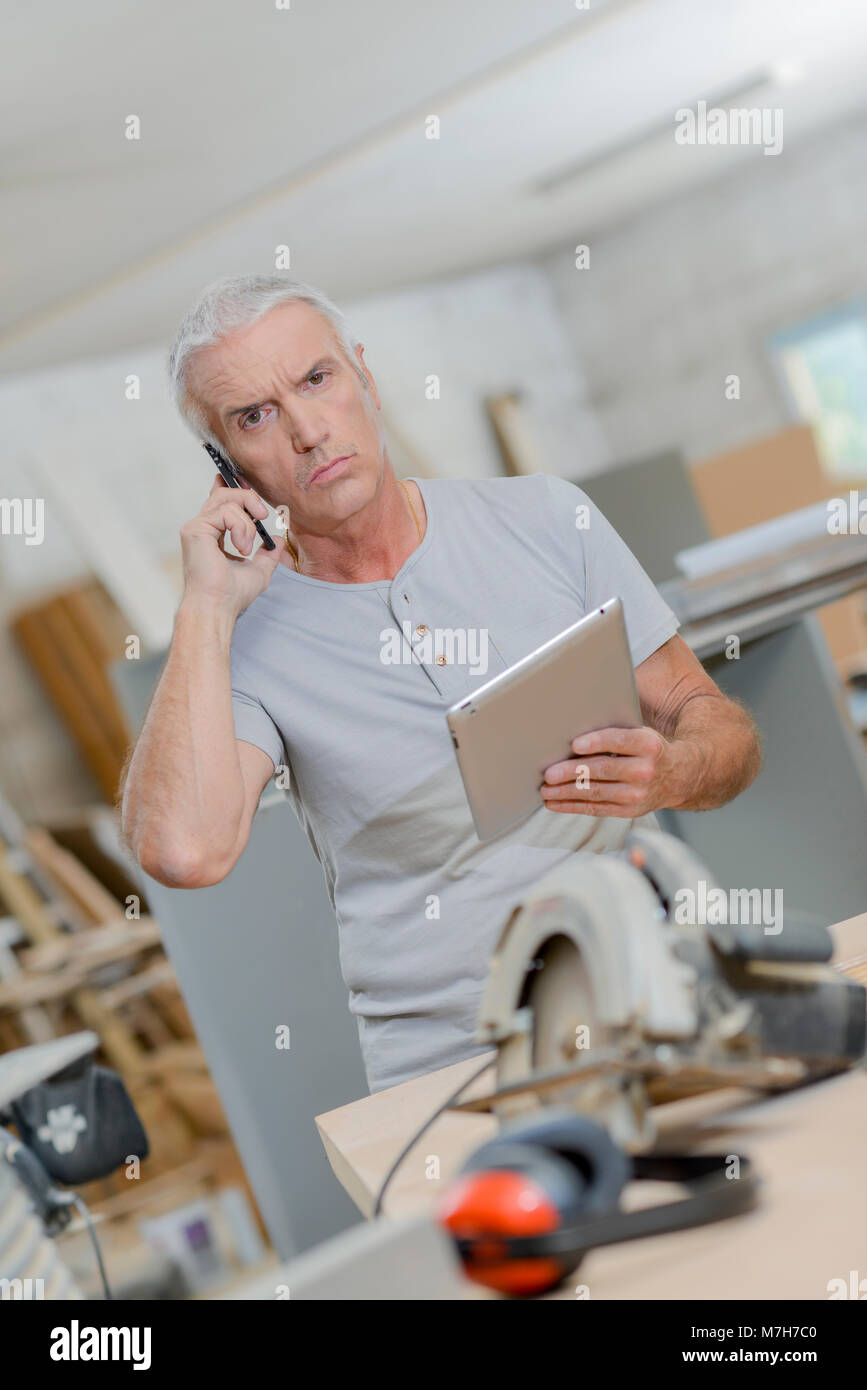 workman on cellphone Stock Photo - Alamy