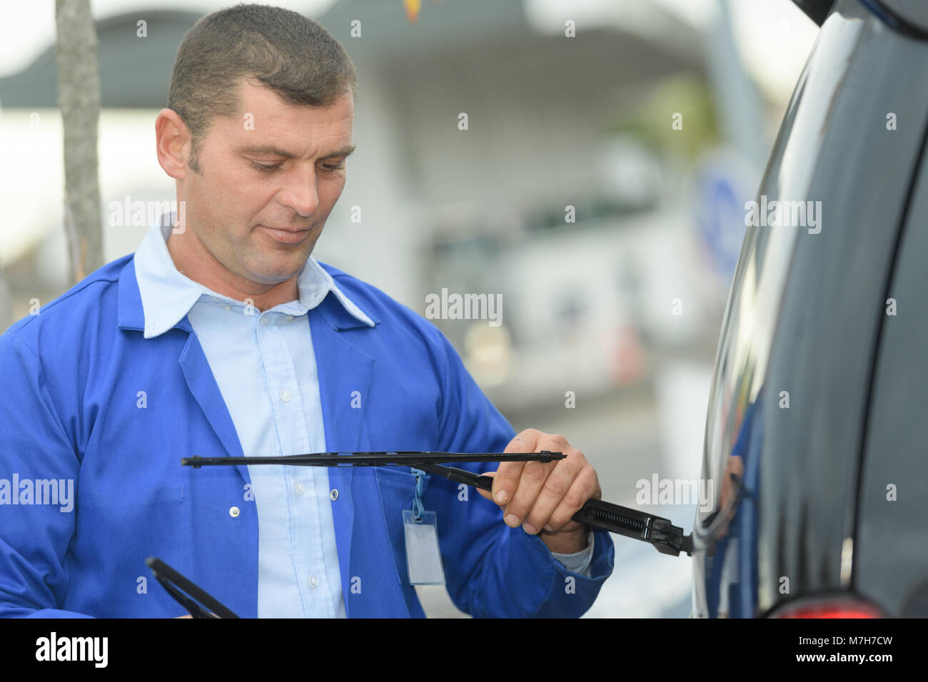 mechanic checking windshield wiper Stock Photo - Alamy