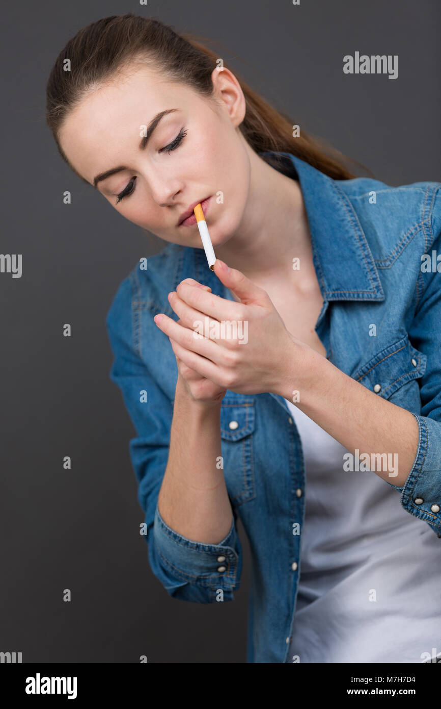 Young lady lighting cigarette Stock Photo - Alamy