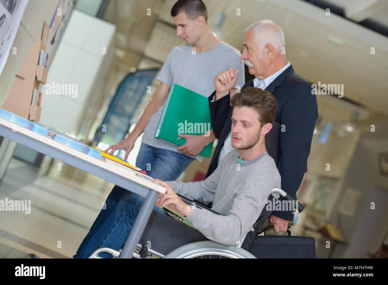 disable young man on a wheelchair studying Stock Photo - Alamy