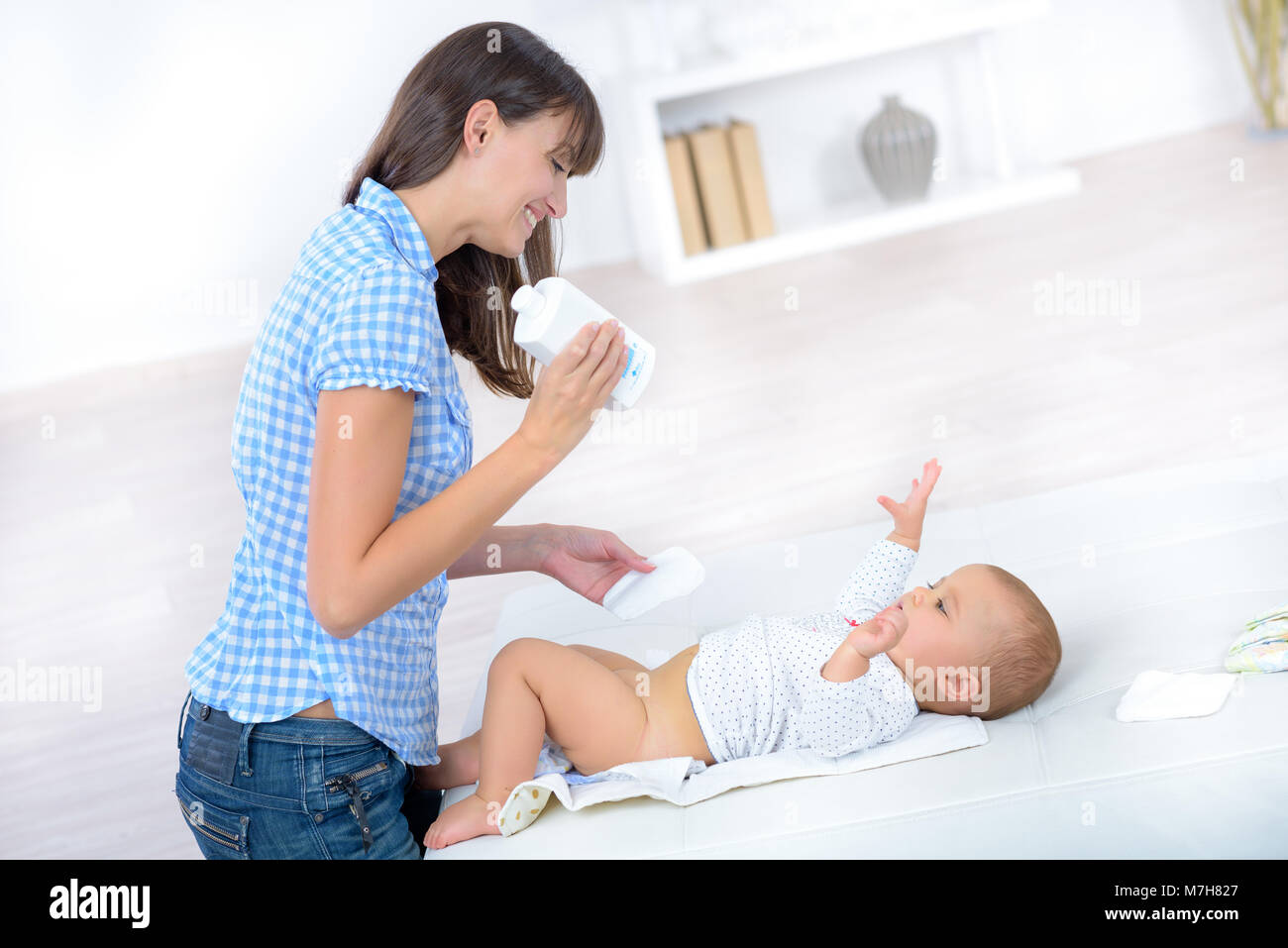 mother changing her babys diaper Stock Photo - Alamy