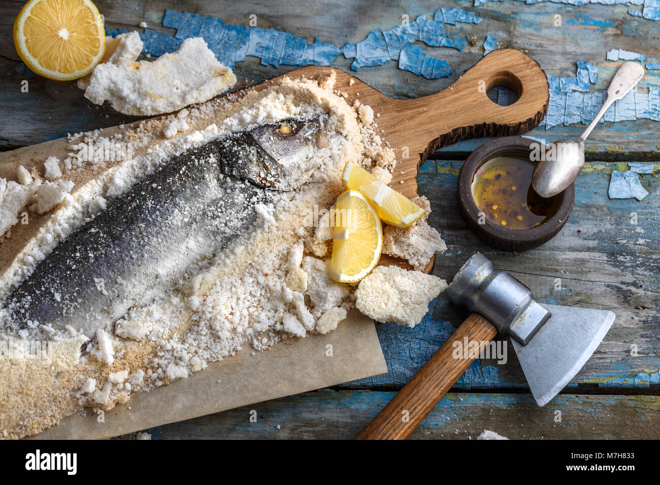 Fish baked in salt with lemon and oil, top view Stock Photo - Alamy