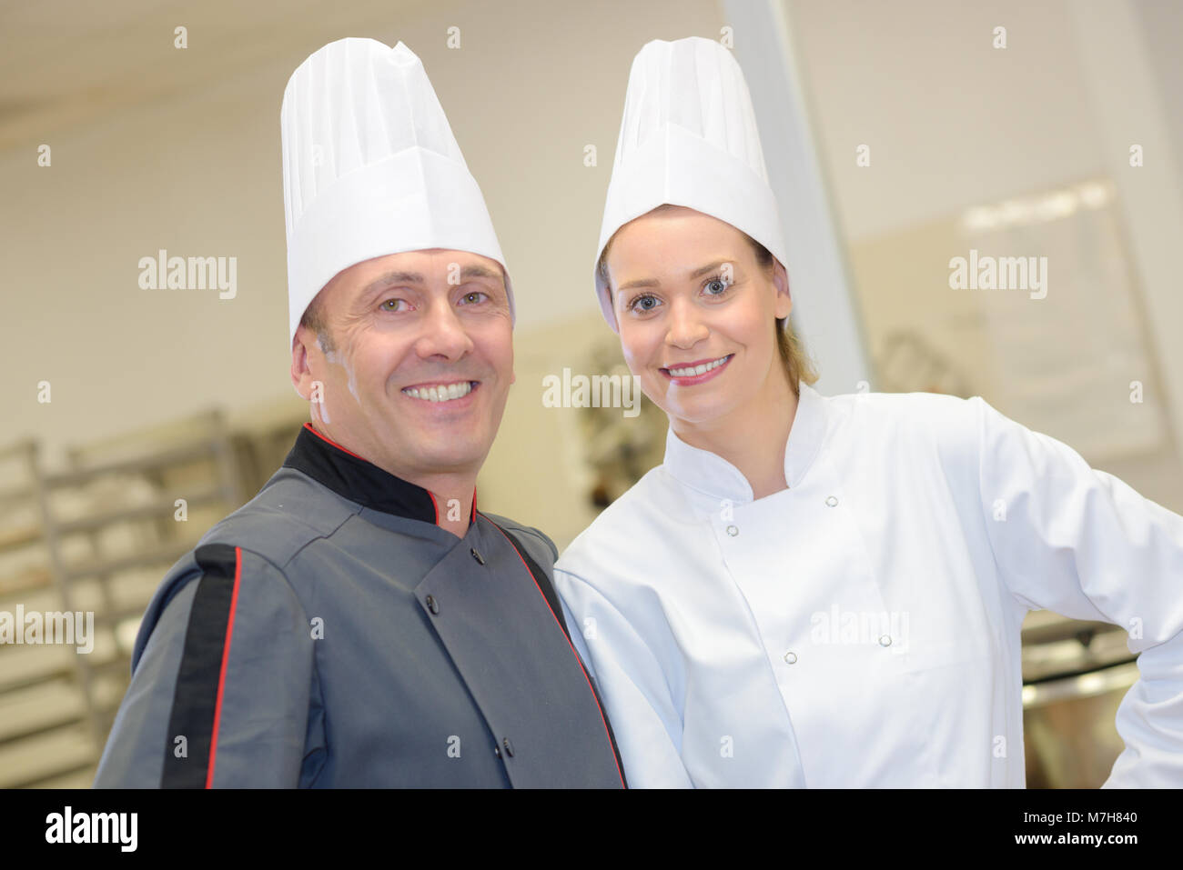 portrait of hospitable chef and his helper at restaurant Stock Photo ...