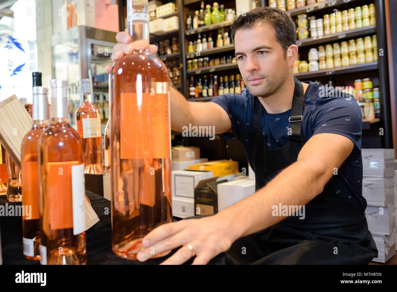 restocking bottles in liquor store Stock Photo - Alamy