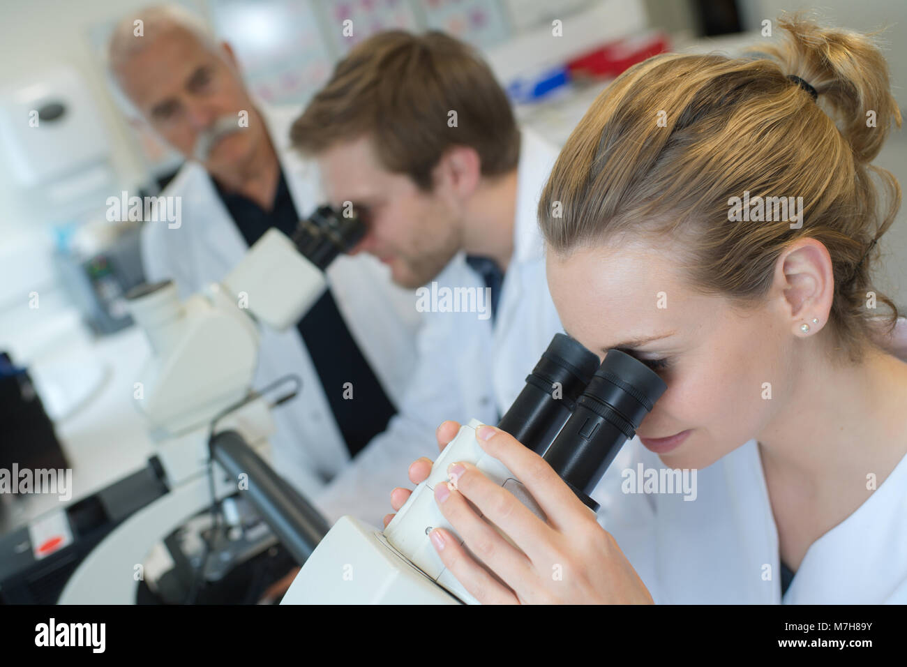 doctors working in the lab with microscope Stock Photo - Alamy