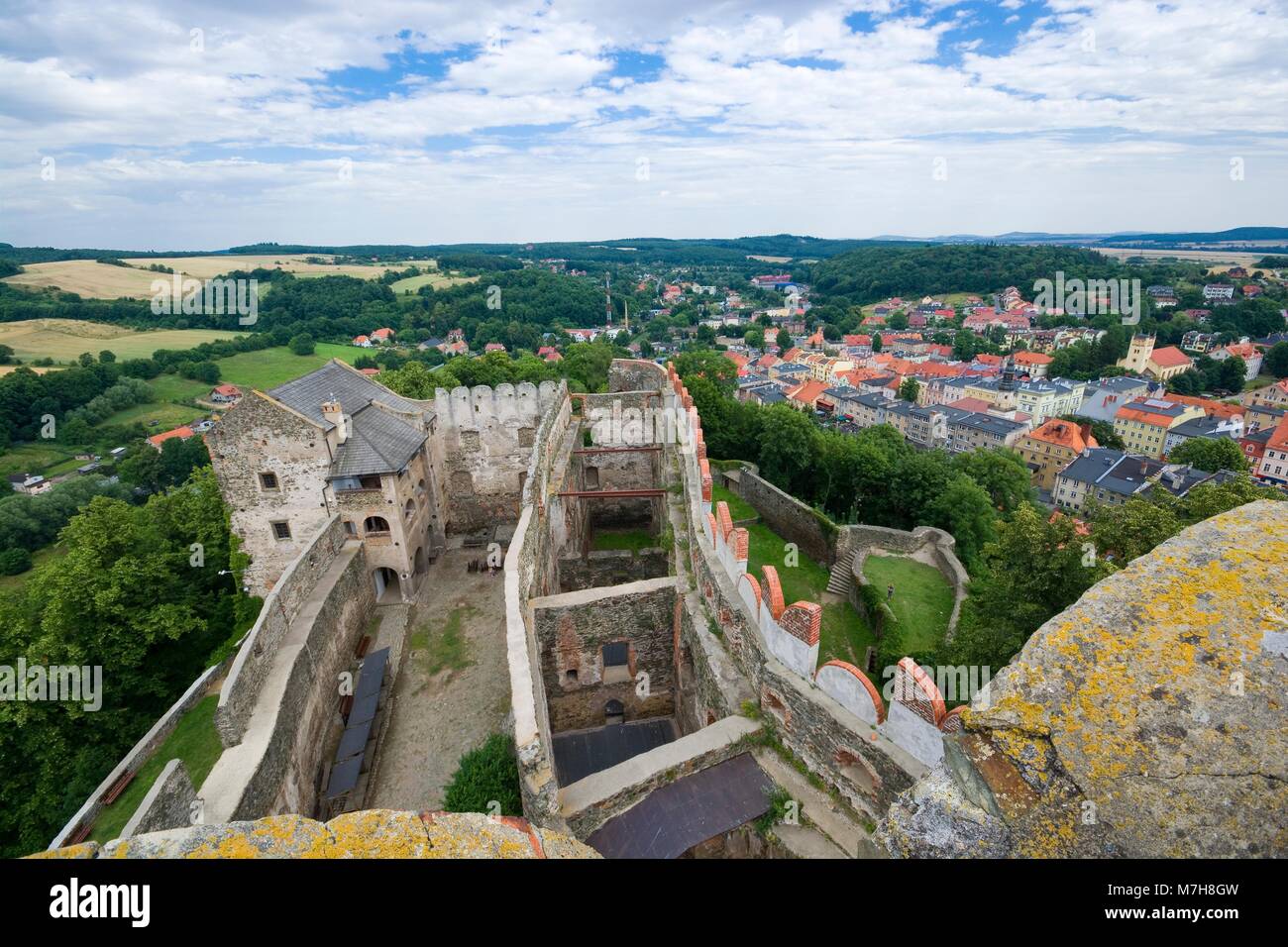 View of ruins of medieval castle situated on the top of high hill ...