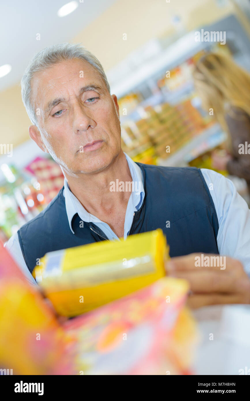 man buying yellow items in shop Stock Photo - Alamy