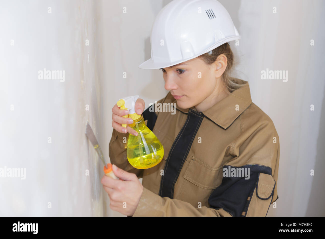 painter scraping the wall Stock Photo - Alamy