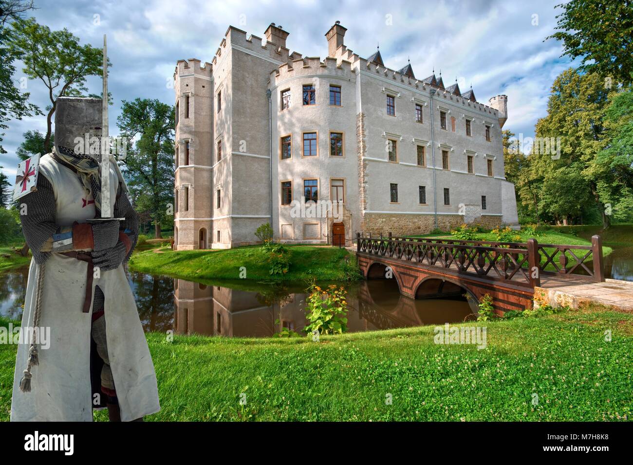 Templar knight with neo-Gothic style castle surrounded by a moat in ...