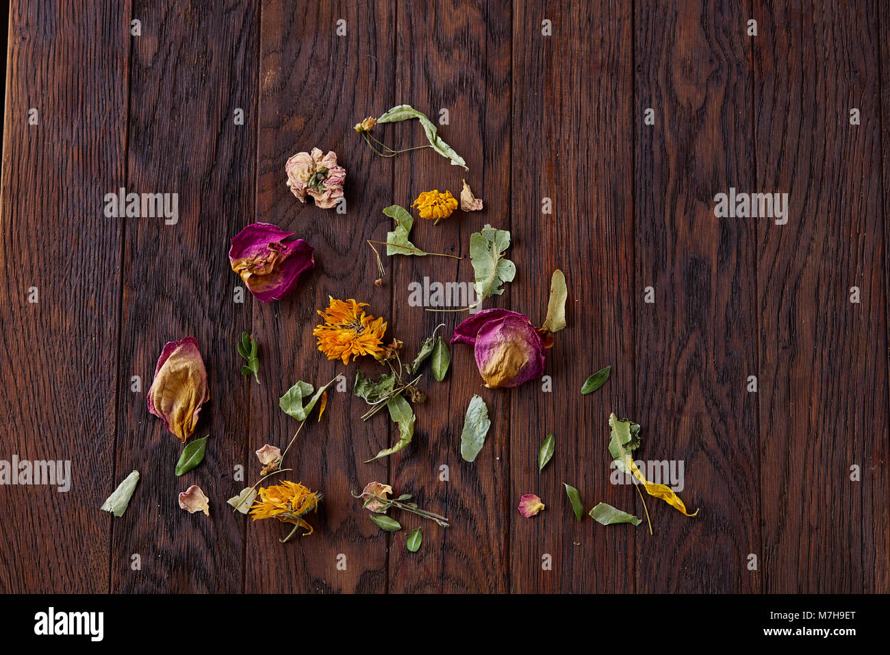 Set of assorted petals isolated on wooden background, close-up ...