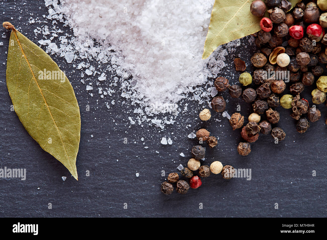 Composition of bay laurel leaf with peppercorn and salt isolated on ...